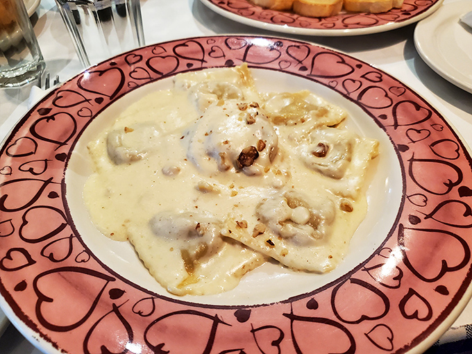Ravioli that looks like it's floating in a cloud of cream sauce, with each pillow promising a flavor explosion that'll make your taste buds stand up and applaud.