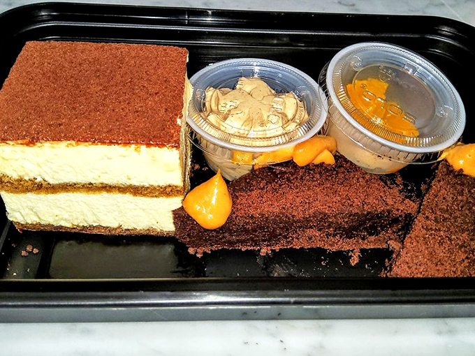 Dessert heaven comes in threes: tiramisu, chocolate cake, and what appears to be pumpkin mousse – a sweet trilogy of satisfaction.