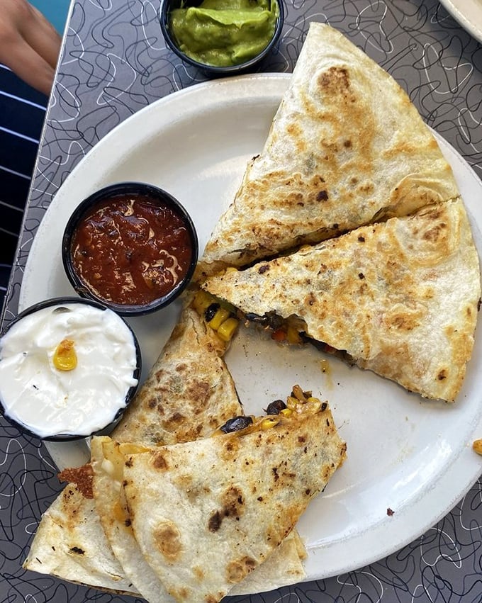 The quesadilla arrives golden and crisp, oozing with melted cheese and stuffed with savory fillings&mdash;comfort food that crosses cultural boundaries with delicious results.