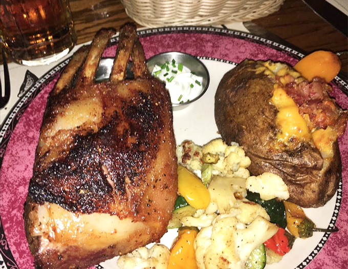 Rack of lamb that's been kissed by fire and blessed by seasoning gods. Paired with a loaded baked potato and vegetables, it's the dinner equivalent of hitting the jackpot.