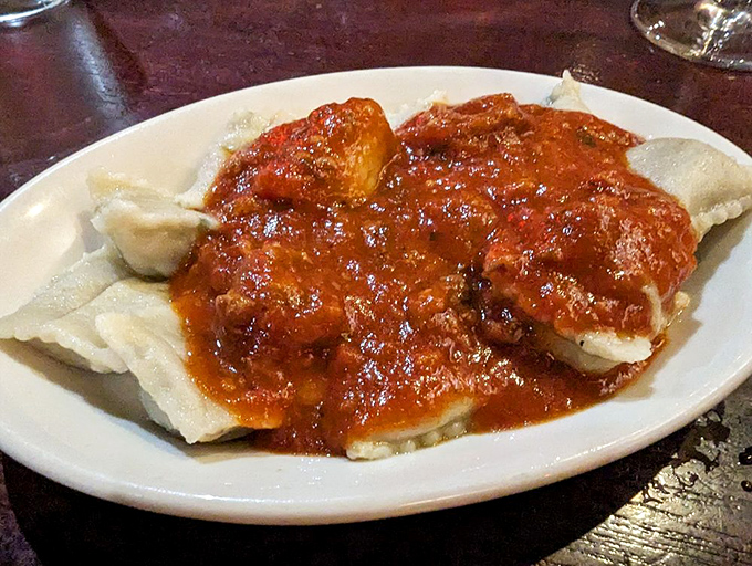 These ravioli aren't just pasta pockets &ndash; they're little envelopes delivering joy directly to your taste buds, swimming in a sea of robust sauce.