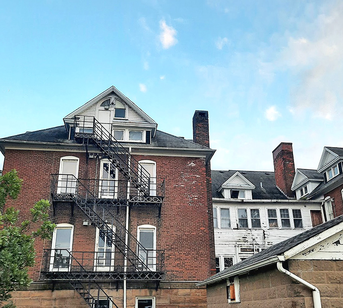 The seminary's fire escape zigzags dramatically against brick walls &ndash; an escape route that some residents likely dreamed of using.