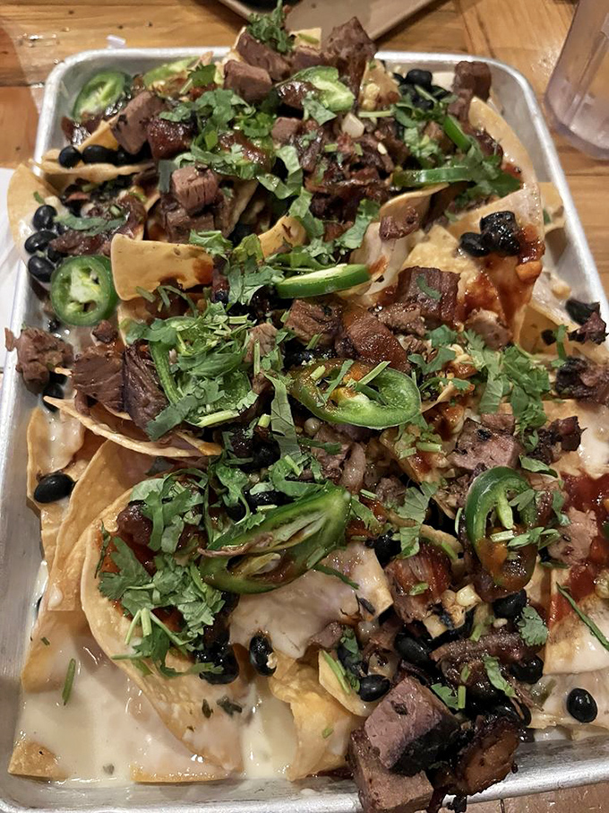 BBQ nachos that laugh in the face of subtlety &ndash; a glorious mess of smoked meat, jalape&ntilde;os, and melted cheese that demands both napkins and respect.