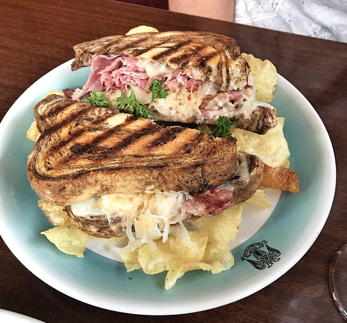 This Reuben sandwich isn't messing around&mdash;grilled to perfection and stacked so high it needs architectural support from those kettle chips.