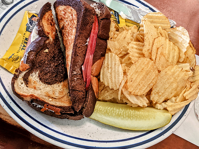 A proper Reuben should require both hands and several napkins. This beauty, with its marble rye and generous filling, delivers on that sacred sandwich promise.