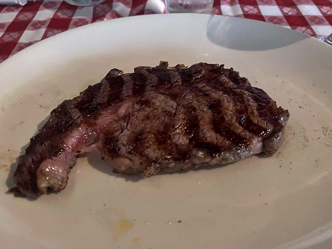 Meat poetry on a plate. The cross-hatched grill marks on this ribeye are like a carnivore's sonnet &ndash; beautiful, precise, and worth savoring slowly.
