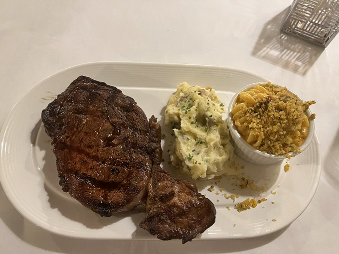 This ribeye commands respect with its impressive char and perfect doneness. Paired with mashed potatoes and mac and cheese, it's comfort food elevated to art.