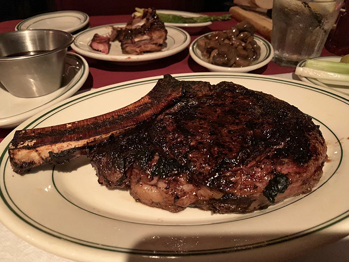 The ribeye arrives like a magnificent meat meteor that crashed onto your plate. That bone isn't garnish&mdash;it's a handle for your meat lollipop.