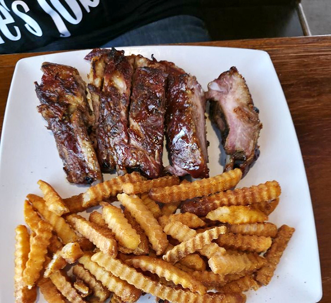 Fall-off-the-bone ribs paired with crispy crinkle fries&mdash;proof that Coosh's barbecue game is just as strong as their Cajun credentials.