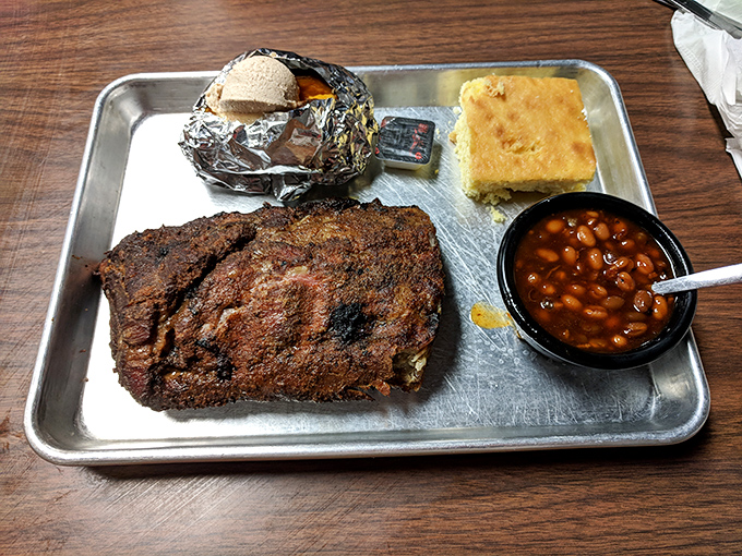 These ribs have clearly been on a long, meaningful journey with smoke and spice. That cornbread isn't just a side&mdash;it's an essential sauce delivery system.