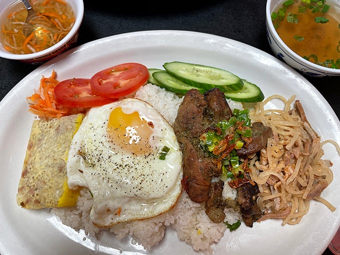 Comfort food gets a Vietnamese passport: tender grilled pork, sunny-side-up egg, and rice create a plate that feels like a warm hug for your taste buds.
