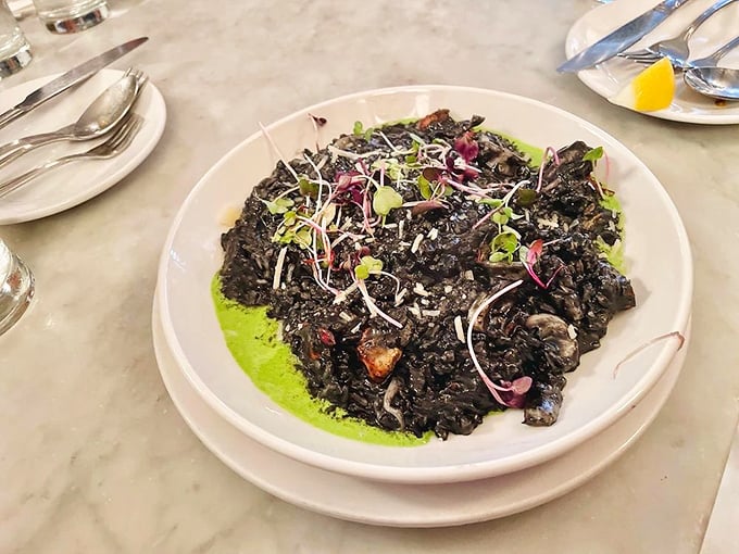 Black squid ink risotto looking like midnight on a plate, tasting like the ocean decided to throw an elegant dinner party.