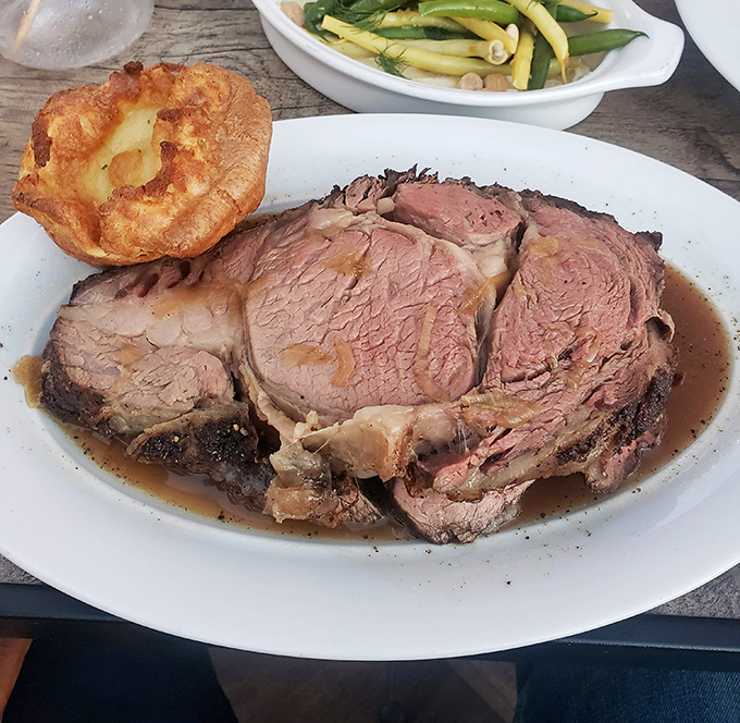 The prime rib at Golden Bull arrives like a carnivore's dream &ndash; perfectly pink, swimming in savory jus, with that Yorkshire pudding standing tall like a proud sidekick.