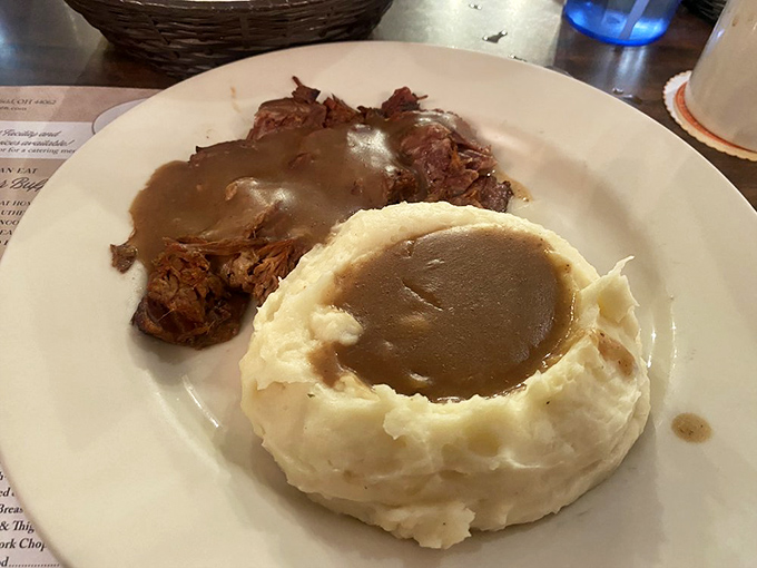 The roast beef practically surrenders to your fork, while the mashed potatoes stand ready to soak up that liquid gold gravy.
