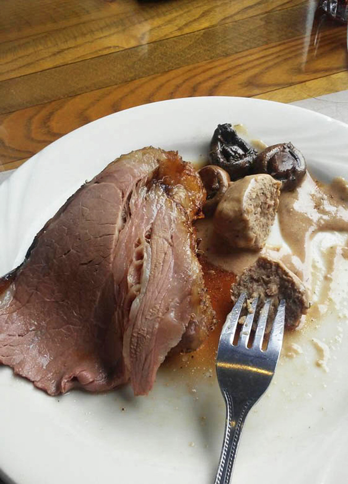 Roast beef sliced thin enough to read through but thick enough to satisfy, lounging in gravy that deserves its own fan club.