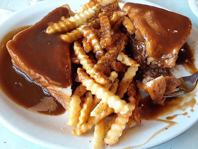 Comfort food doesn't get more comforting than this &ndash; a tender pot roast swimming in rich gravy alongside crispy fries that deserve their own fan club.