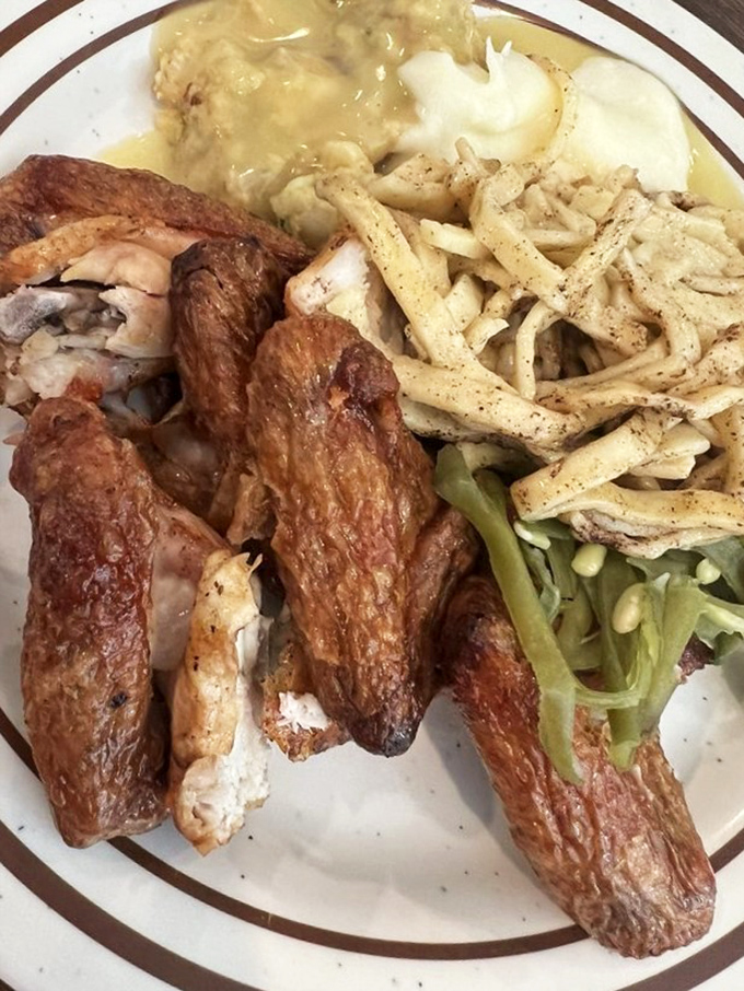 Rotisserie chicken with a golden-brown exterior that crackles with each bite. Paired with those seasoned home fries, it's comfort on a plate.