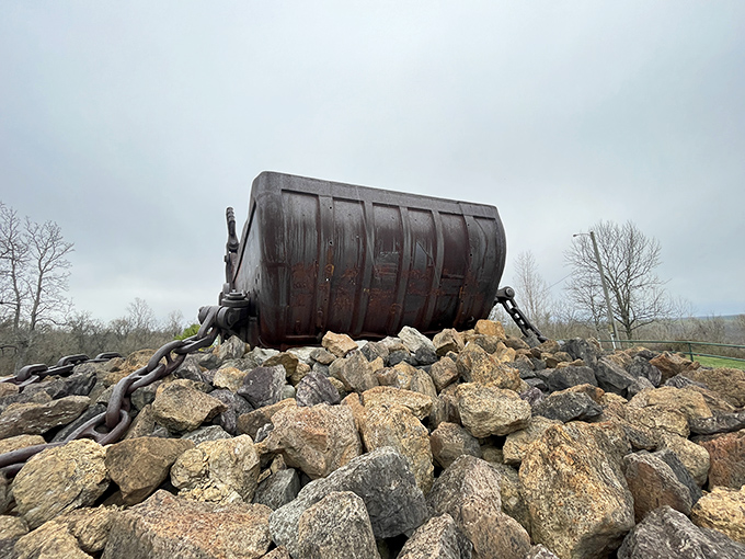 Like a sleeping dragon guarding its rocky hoard, the bucket's weathered profile stands sentinel against the Ohio sky.