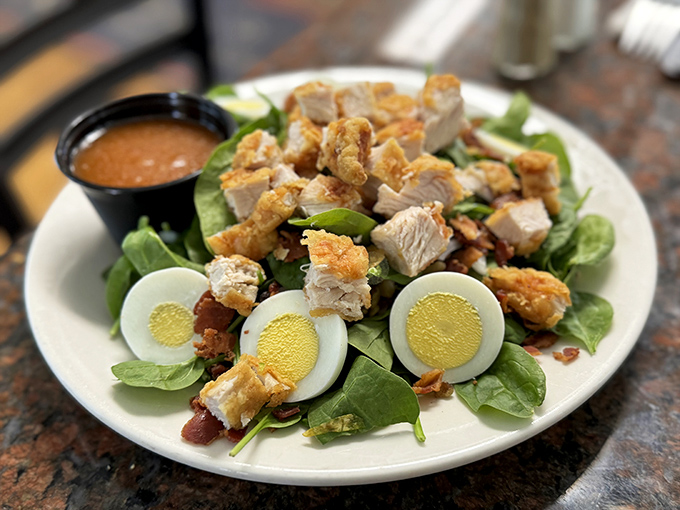 Salads elsewhere are obligation eating; this one's a destination&mdash;crisp greens, perfectly cooked chicken, and hard-boiled eggs arranged with obvious care.