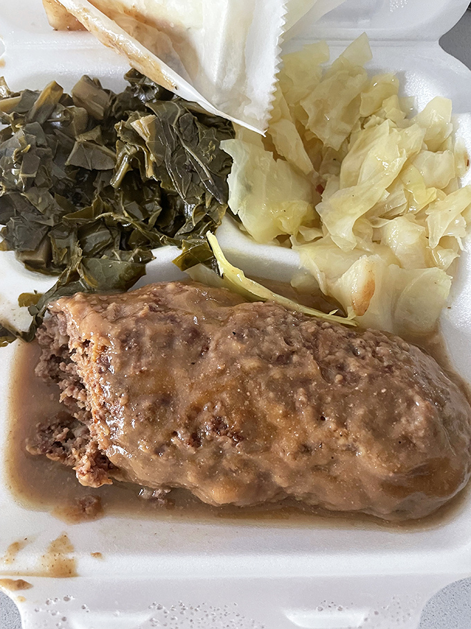 Comfort on a plate: tender meatloaf swimming in savory gravy alongside collards and cabbage. Southern grandmothers everywhere would give this their seal of approval.