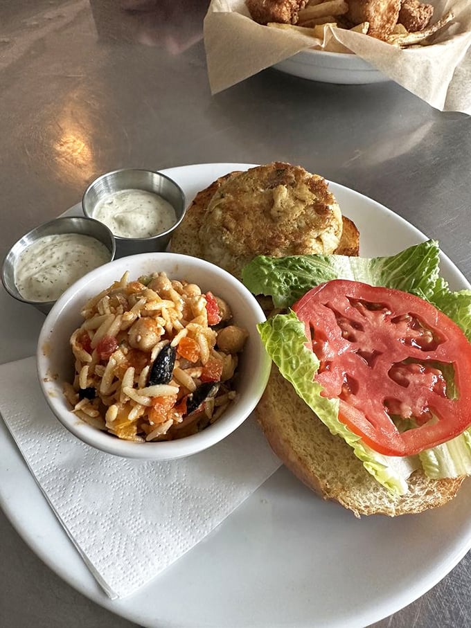A crab cake sandwich that actually tastes like crab? Revolutionary! Paired with a side of what appears to be seafood pasta salad.