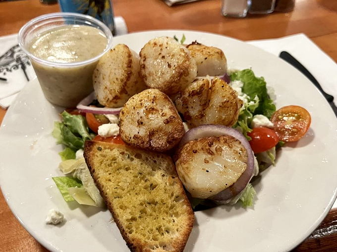 These scallops aren't just cooked&mdash;they're respected. Perfectly seared and served atop a garden of greens, they're the ocean's butter in its finest form.