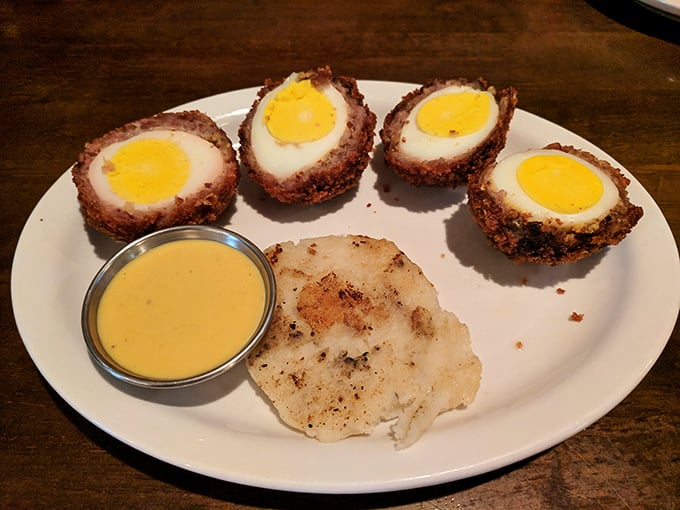 Scotch eggs that have clearly earned their PhD in comfort food &ndash; crispy exterior giving way to savory meat and that perfect yolk center. Diploma-worthy deliciousness.