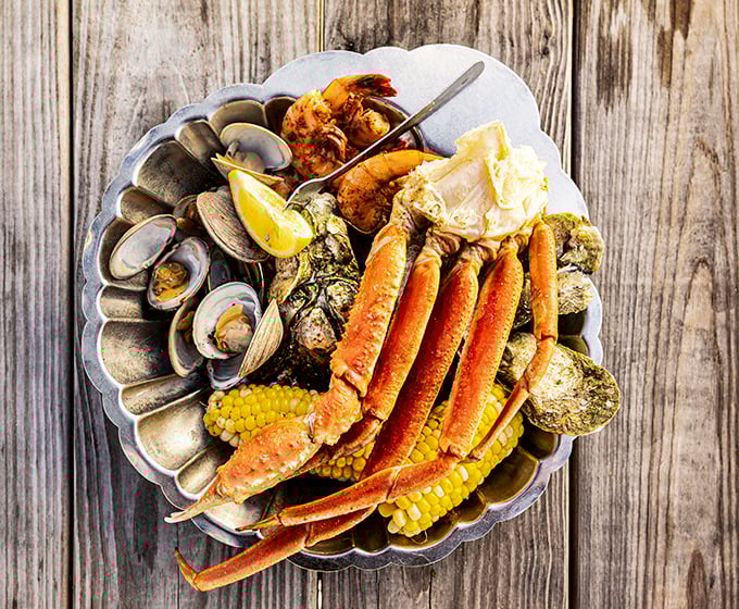 The seafood boil that launched a thousand bibs &ndash; crab legs stretching across the plate like they're trying to escape their delicious fate.