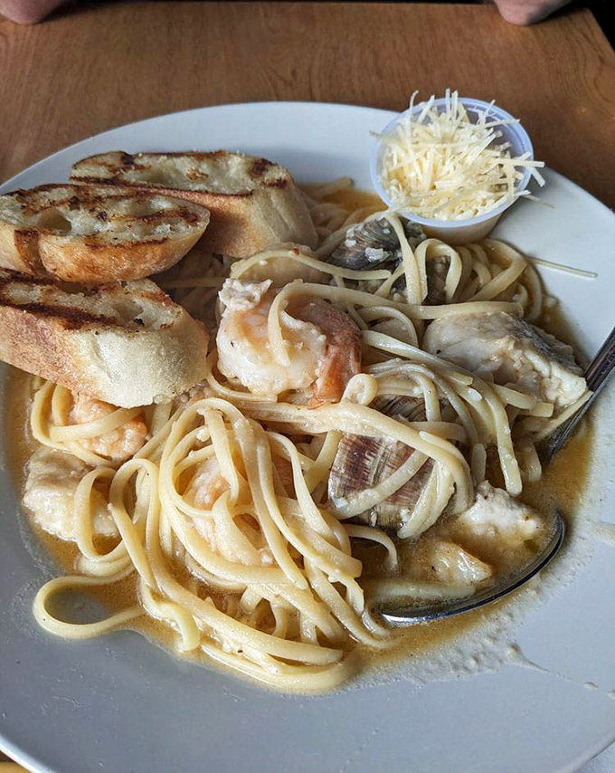 Seafood pasta that makes you wonder why anyone eats noodles without shellfish. Those shrimp aren't just swimming in sauce&mdash;they're doing the backstroke in flavor.