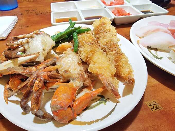 Crab legs and tempura shrimp sharing a plate like old friends at a reunion. The kind of seafood platter that makes you consider moving to the coast permanently.