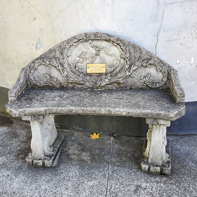 This ornate stone bench offers weary travelers a moment to contemplate life's big questions&mdash;like "Who builds a building shaped like a coffee pot?"