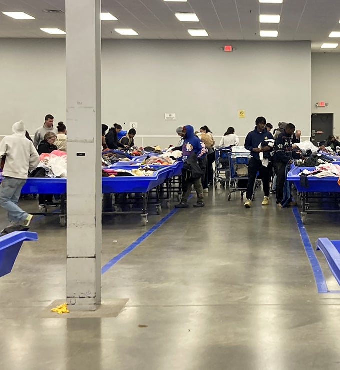 The blue bin brigade in action! Seasoned shoppers know to move with purpose when fresh merchandise hits the floor.