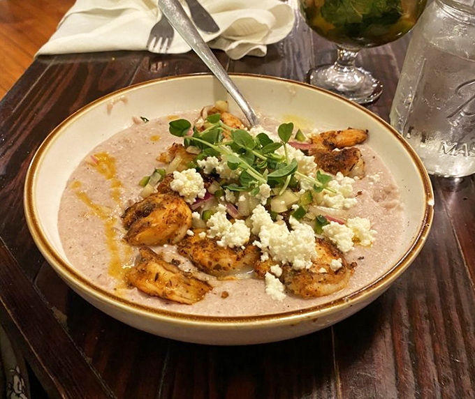Shrimp and grits elevated to an art form, where creamy cornmeal becomes a canvas for seafood that practically jumped from the ocean to your plate.