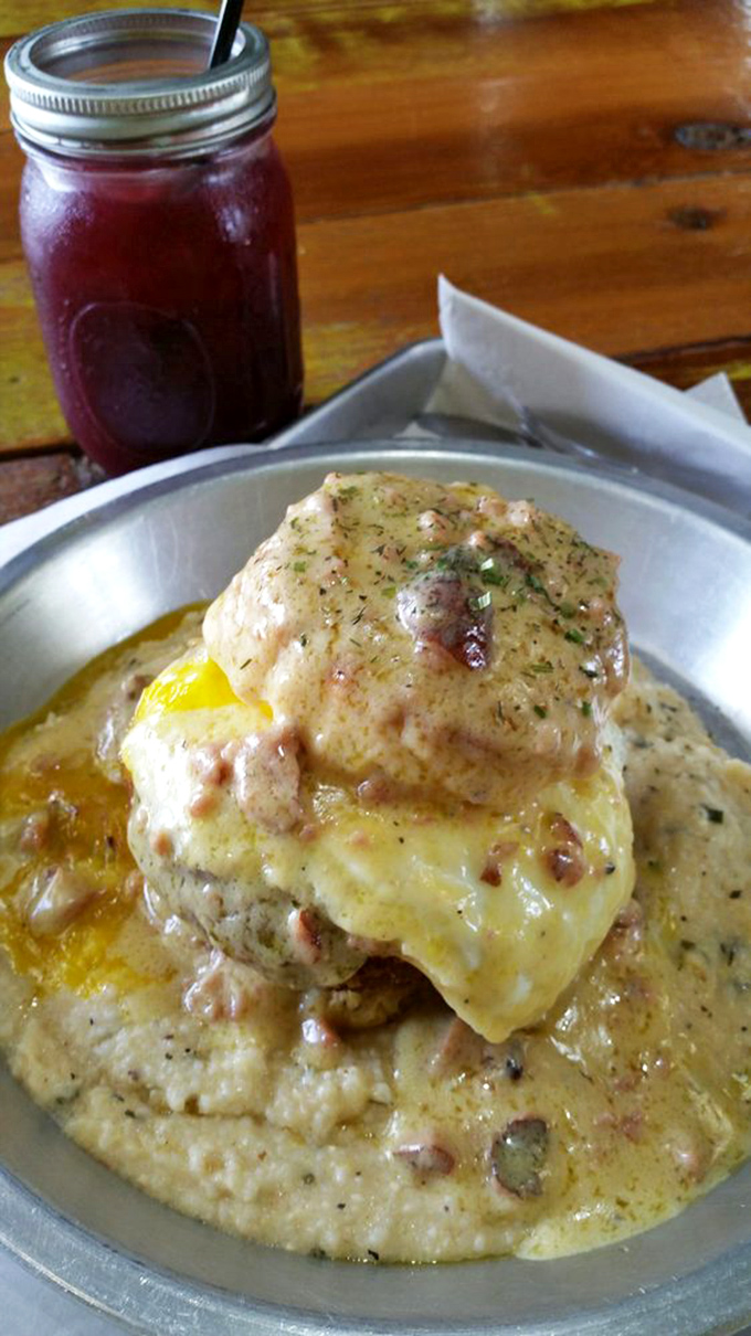 Grits transcend their humble origins here, becoming a creamy throne for a perfectly cooked egg and what appears to be heavenly gravy.