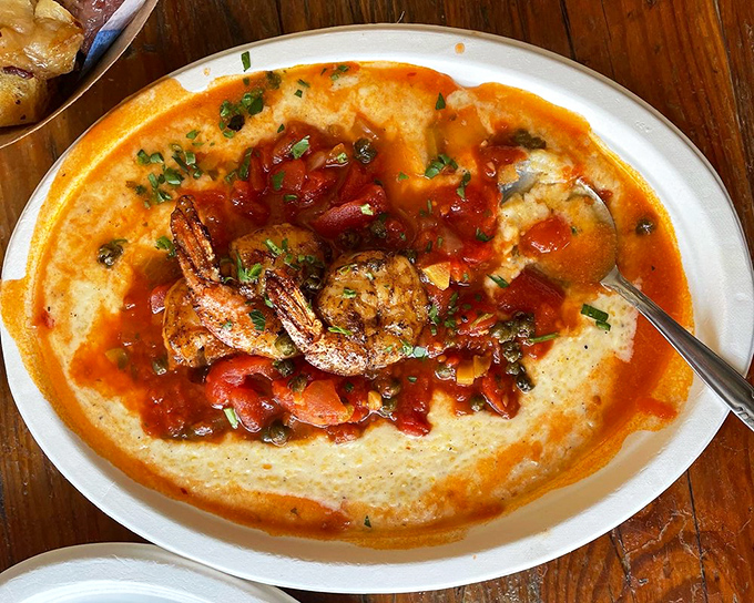 Shrimp and grits get the Chicago treatment &ndash; bold, unapologetic, and ready to impress. That orange-red sauce isn't playing around.