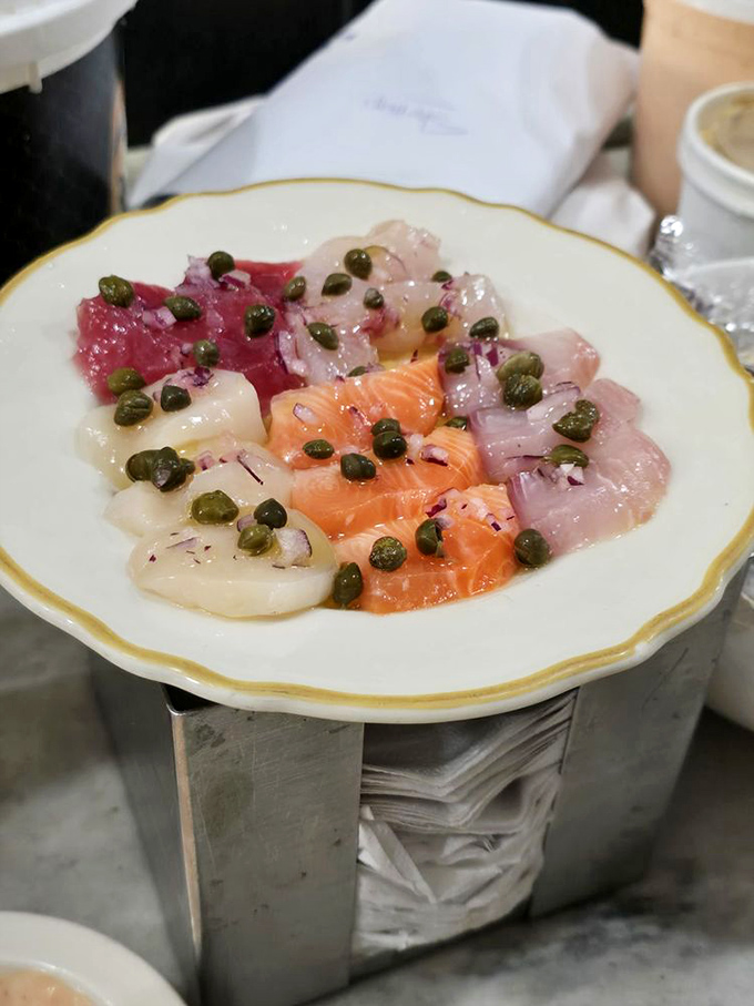 Sicilian sashimi &ndash; a colorful mosaic of the ocean's finest, adorned with capers and olive oil. Who needs cooking when raw perfection exists?