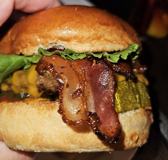 This bacon burger doesn't just have bacon&mdash;it celebrates it. The pickle is there for moral support and tang management.