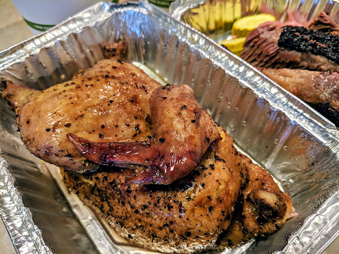 Smoked chicken that's had a proper spa day of seasoning and slow cooking. The skin glistens like it just won a beauty pageant.