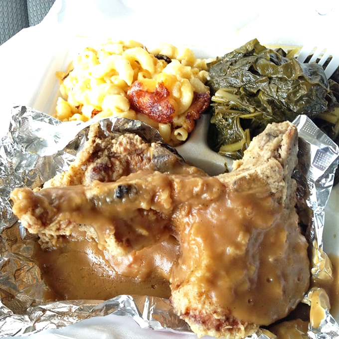 Soul food alchemy at its finest—smothered pork chops with mac and cheese and greens. The holy trinity of comfort on a single plate.