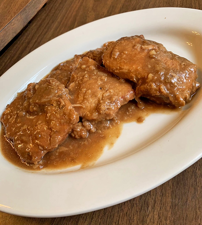These smothered pork chops aren't just swimming in gravy&mdash;they're doing the backstroke in flavor country. Fork-tender doesn't begin to describe it.