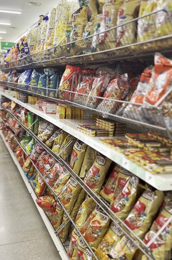 An entire aisle dedicated to snacking temptation, where every bag whispers "take me home" in your budget's language.