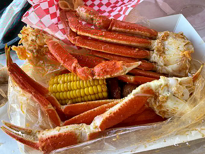 Snow crab legs sprawled out like they're sunbathing on a plastic beach. The corn on the cob is just there to make the crabs feel less naked.