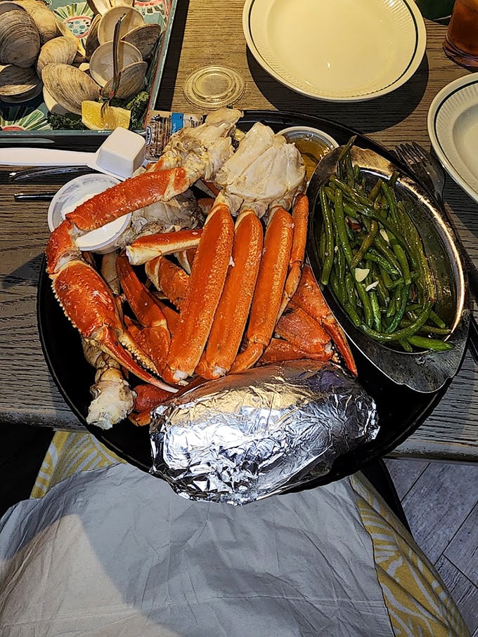 Snow crab legs arranged like a seafood sculpture, with green beans standing by for the obligatory vegetable appearance.