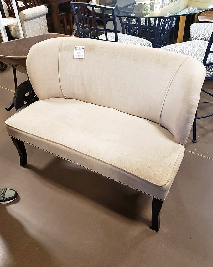 This elegant cream settee isn't just furniture&mdash;it's a statement piece with stories to tell. Imagine the conversations it could host in your living room.