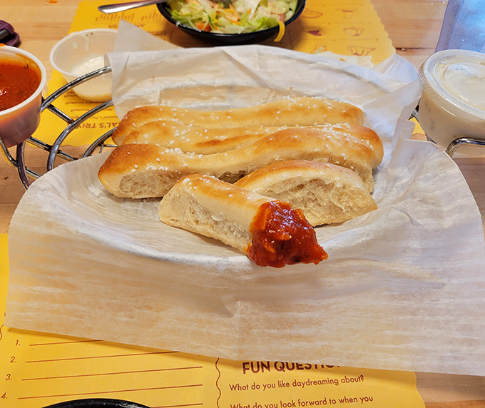 Soft dough breadsticks: the opening act that sometimes steals the show. That little puddle of marinara is about to experience a very swift disappearing act.