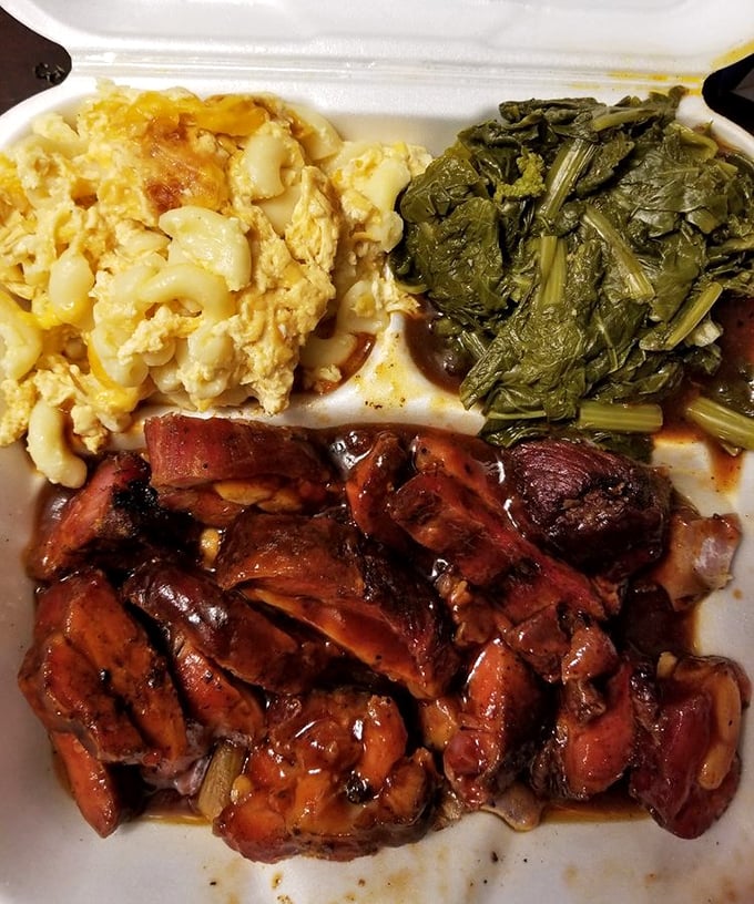 The holy trinity of soul food: mac and cheese, collard greens, and barbecue so tender it practically surrenders at the sight of your fork.