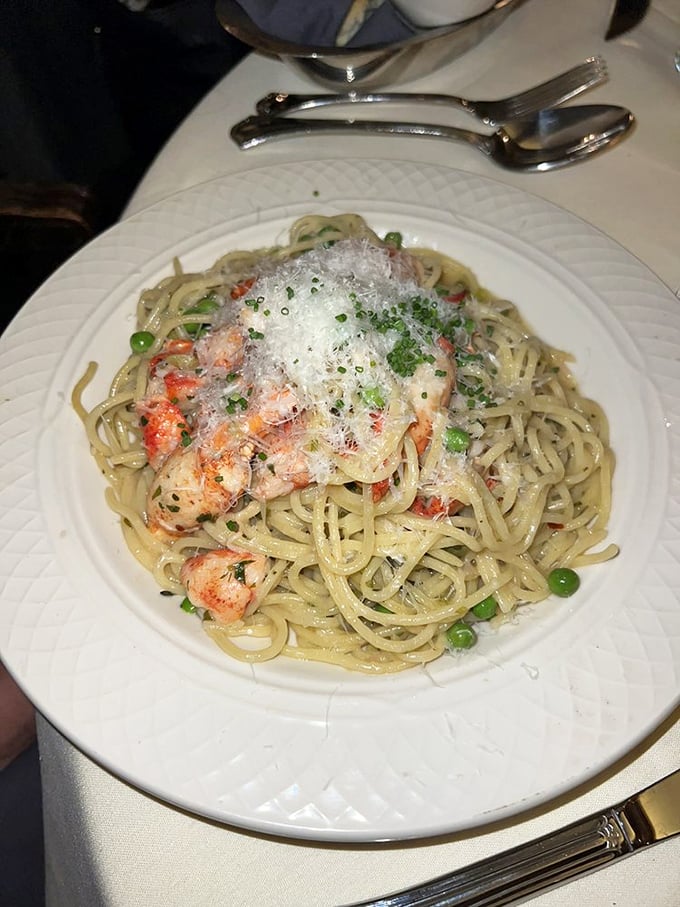 Pasta elevated to art form&mdash;delicate strands cradling seafood beneath a snowfall of freshly grated cheese.