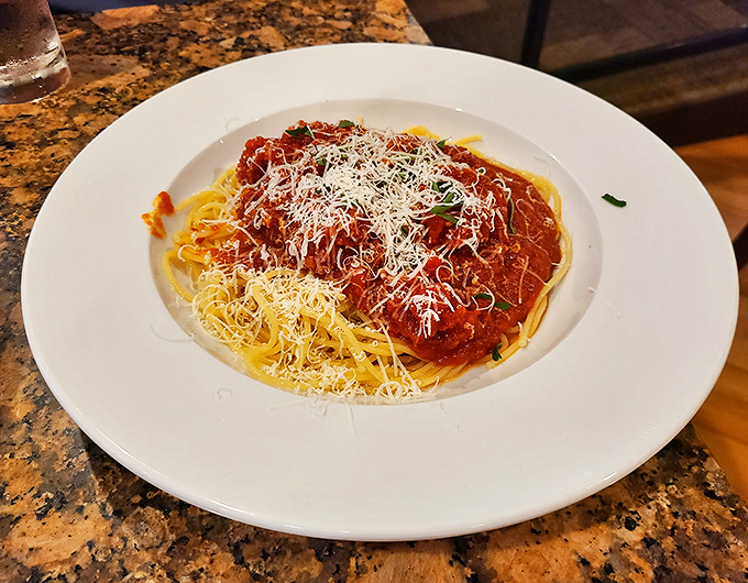 Spaghetti Bolognese that doesn't just sit on the plate&mdash;it tells a story of slow-simmered tradition crowned with a snowfall of Parmesan.