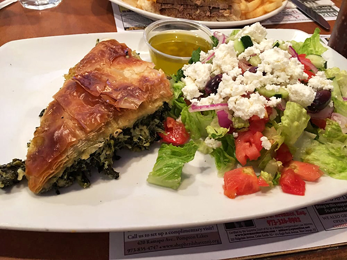 The spinach pie's flaky phyllo practically shatters at first touch, while that Greek salad alongside offers the perfect tangy counterpoint. Mediterranean vacation on a plate.