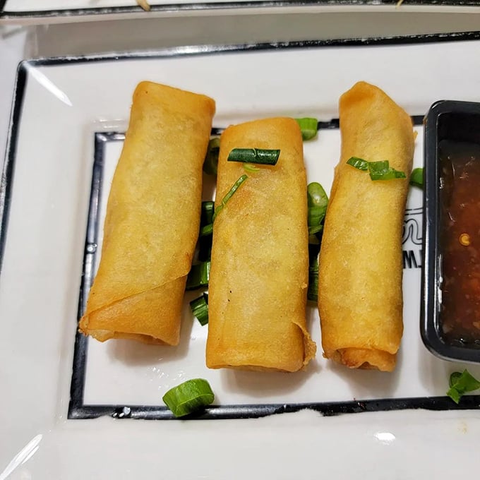Golden, crispy spring rolls that shatter with each bite. These cylindrical treasures are the perfect vehicle for that sweet-spicy dipping sauce.